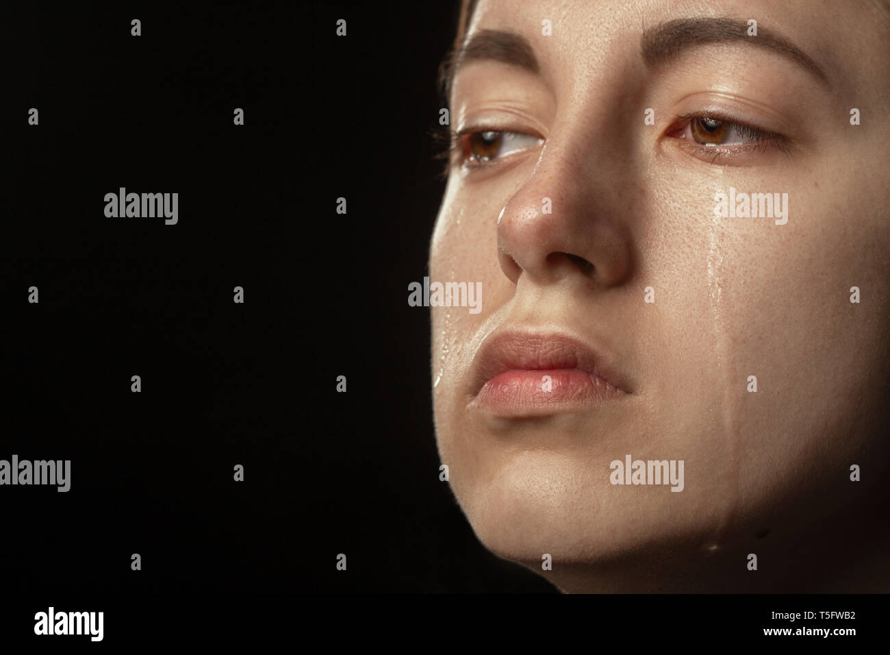 sad woman crying on black background, closeup portrait Stock Photo - Alamy