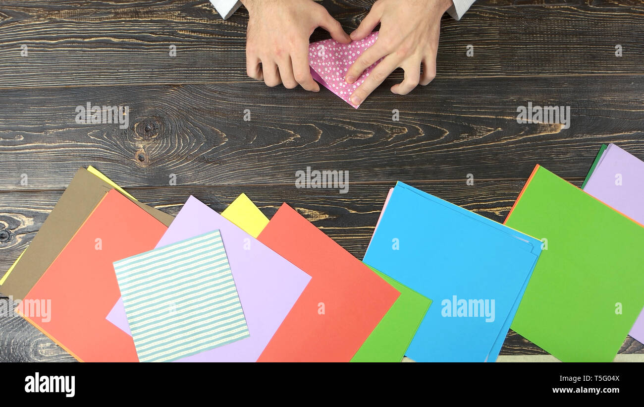 Hands making origami, top view Stock Photo - Alamy