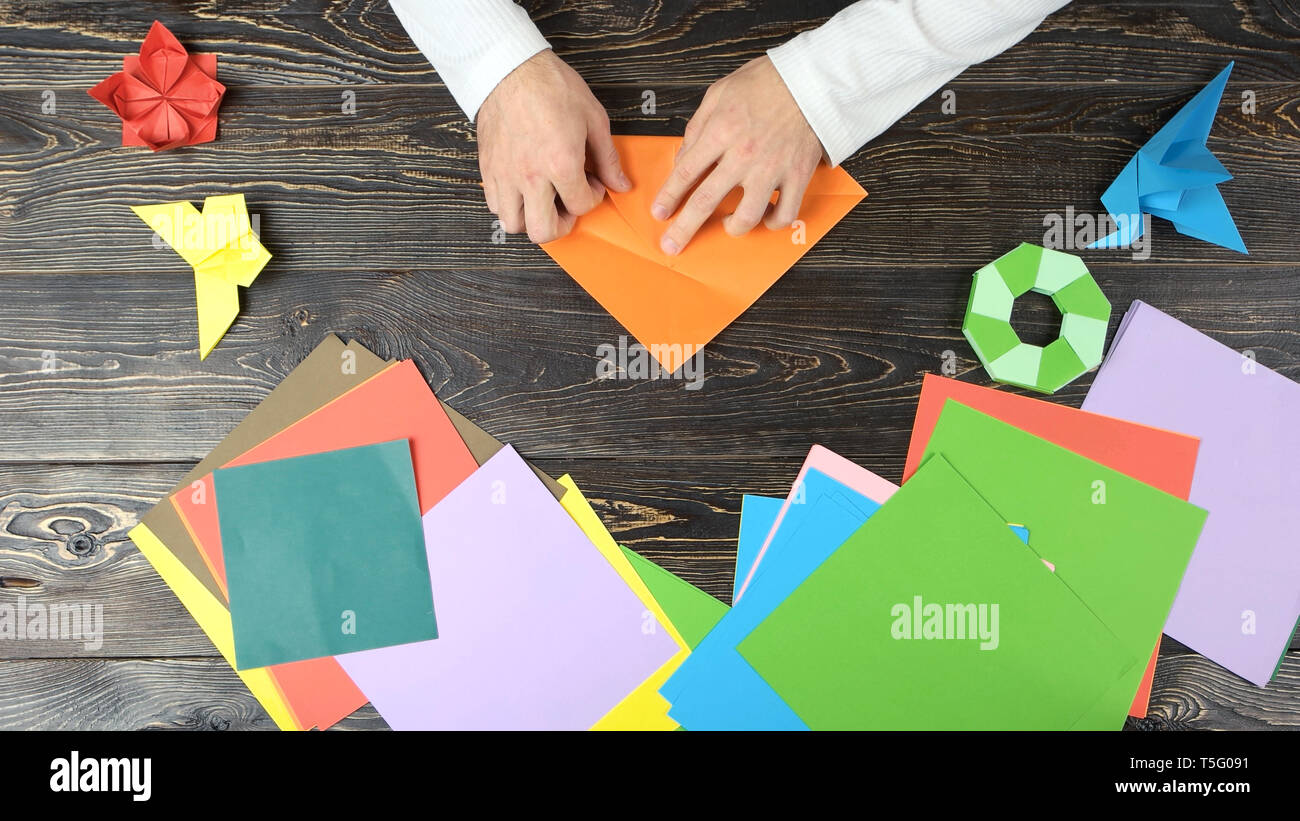 Folding origami paper in triangle, top view Stock Photo - Alamy