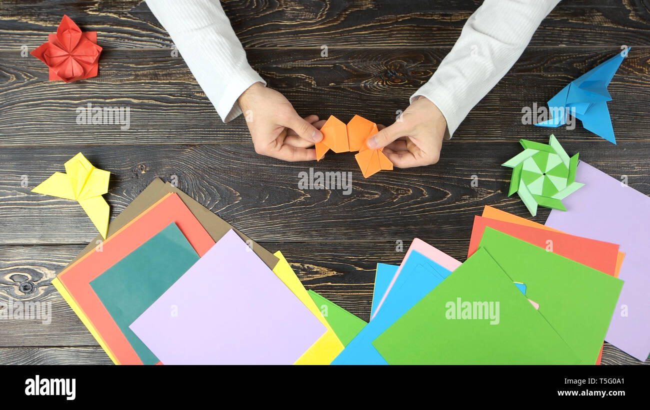 Young man making origami hi-res stock photography and images - Alamy