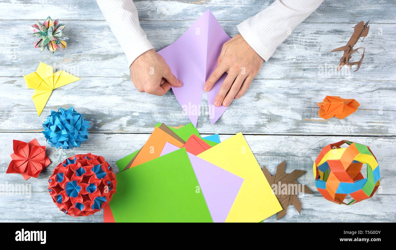 Making origami purple triangle Stock Photo - Alamy