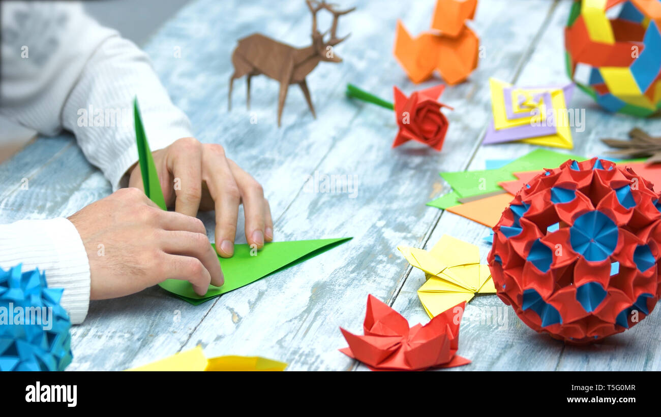 Man at origami folding lesson Stock Photo - Alamy