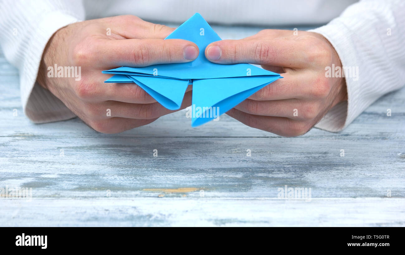 Hands folding origami hi-res stock photography and images - Alamy