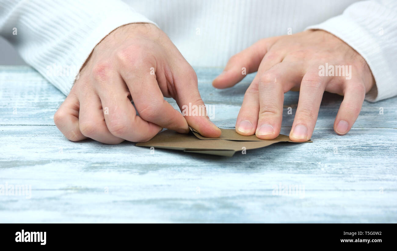 Male hands making figure from paper Stock Photo - Alamy