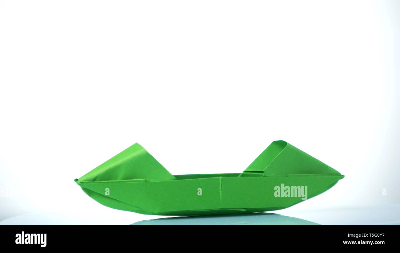 Green paper boat on white background Stock Photo - Alamy