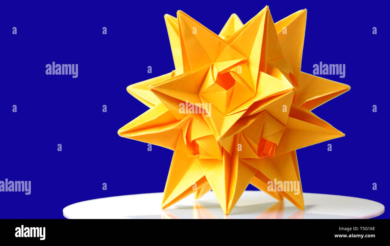 Stellated dodecahedron origami on blue background Stock Photo - Alamy