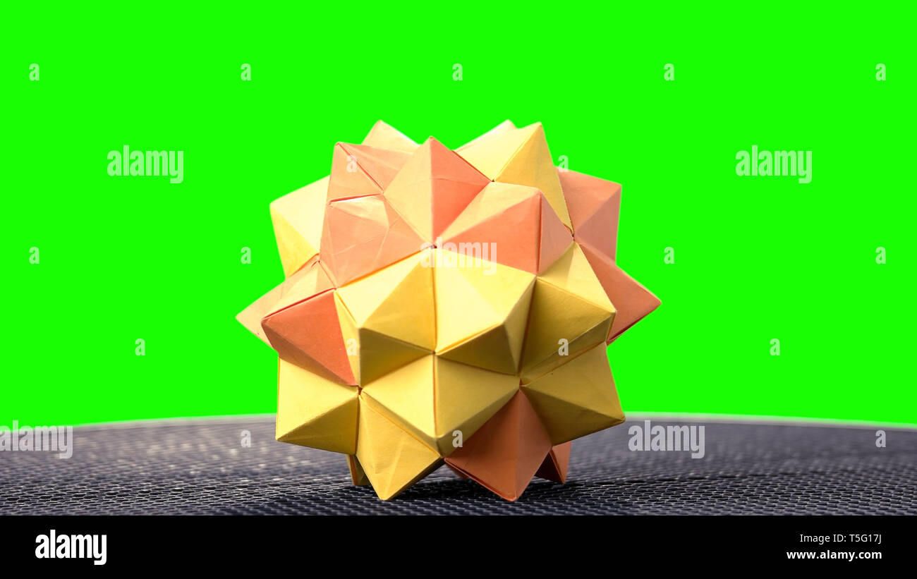 Modular origami model on green background Stock Photo - Alamy