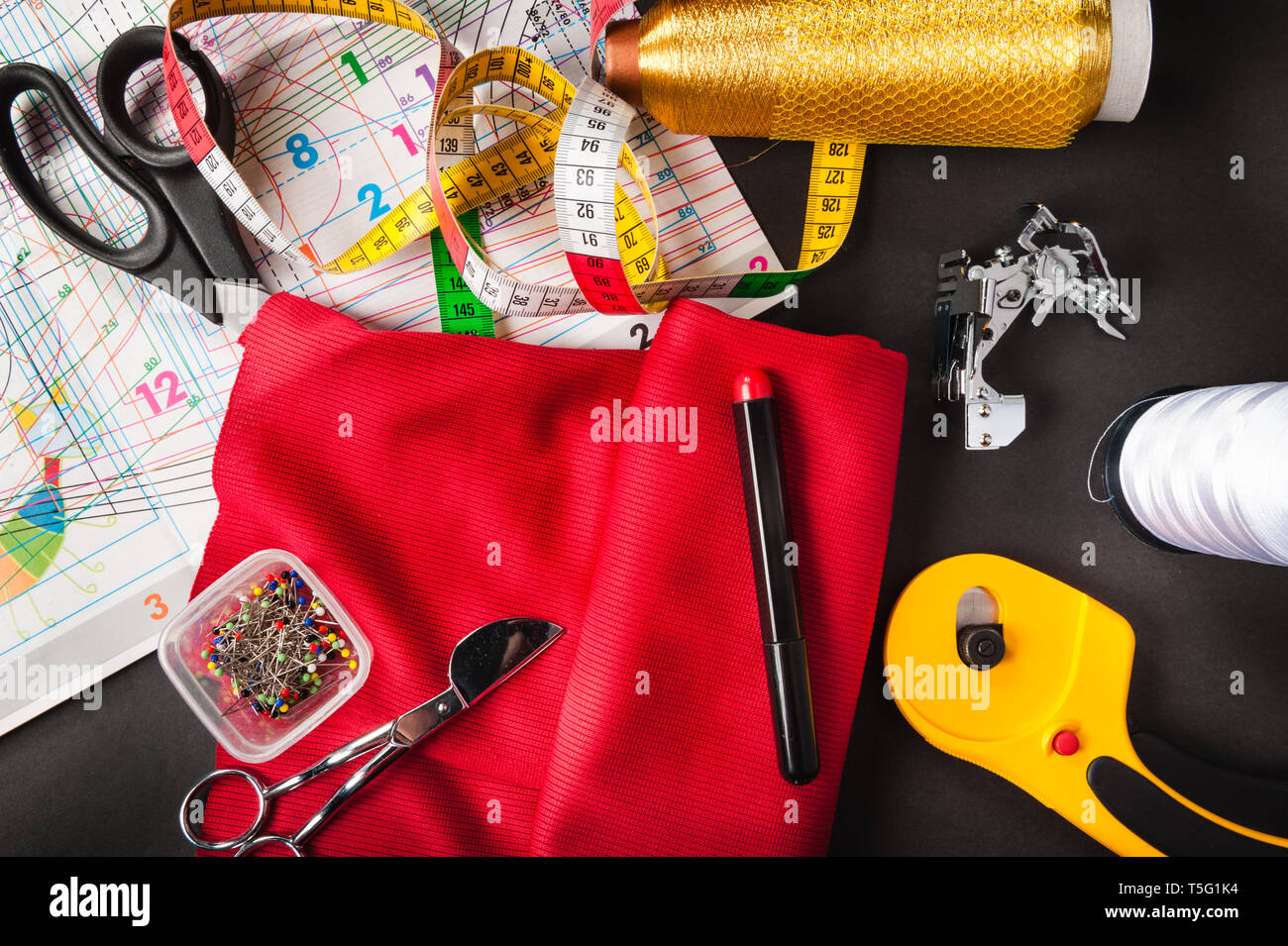 sewing tools thread with scissors and measuring tape on dark Stock ...
