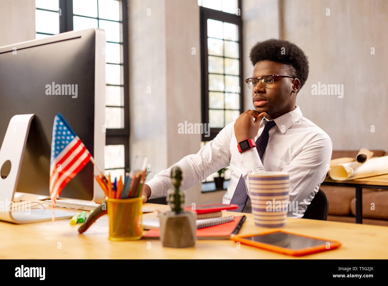 Serious in an office american flag hi-res stock photography and images ...