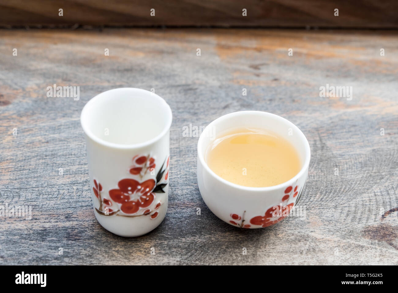 Oolong tea in the traditional Chinese style cup with the floral pattern ...
