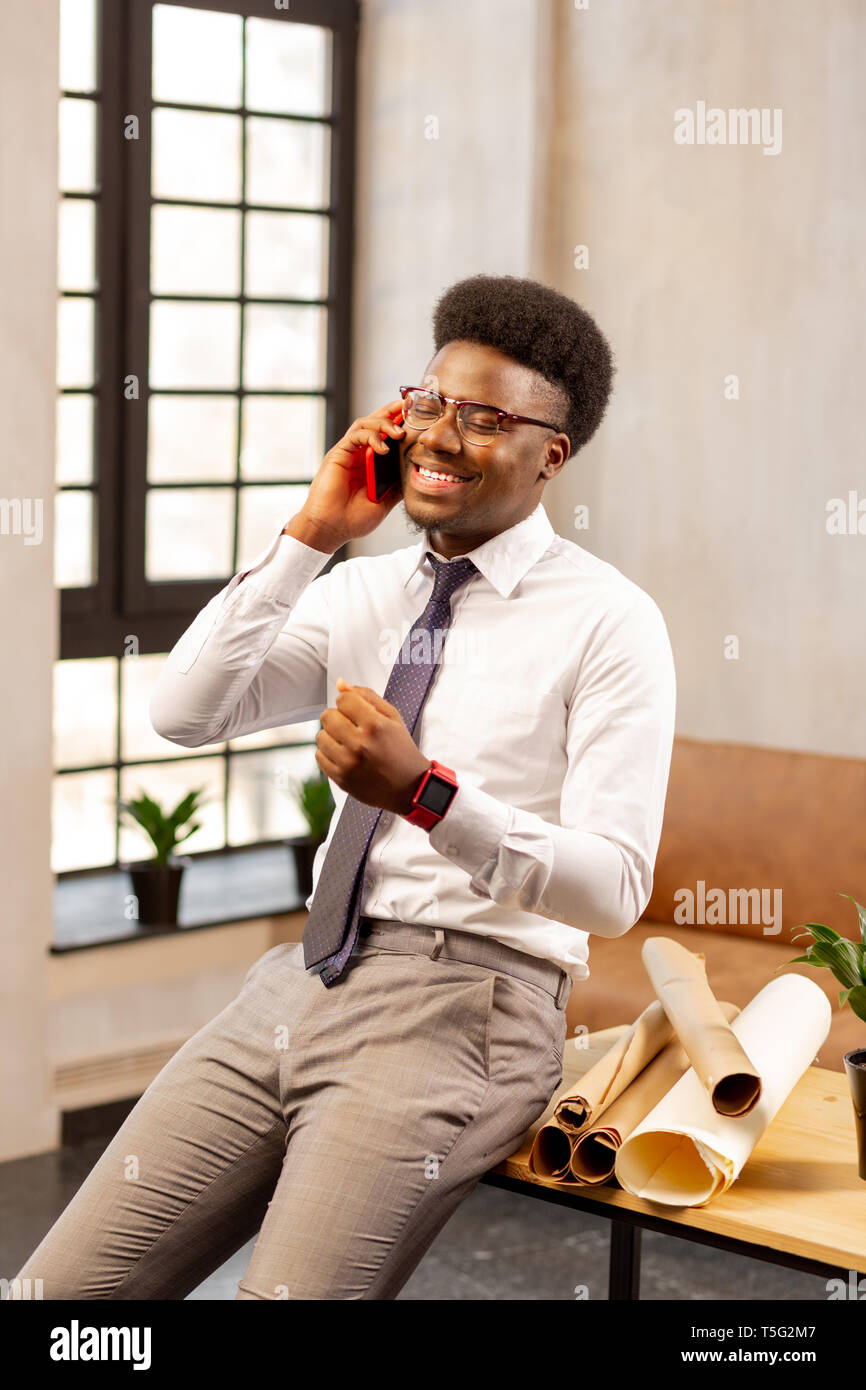 Positive cheerful man speaking with his client Stock Photo - Alamy