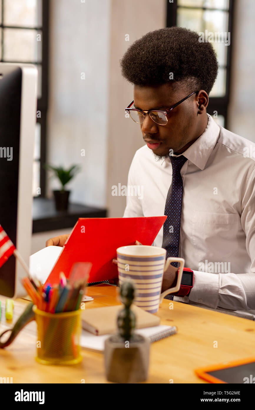Smart young office worker doing his job Stock Photo - Alamy