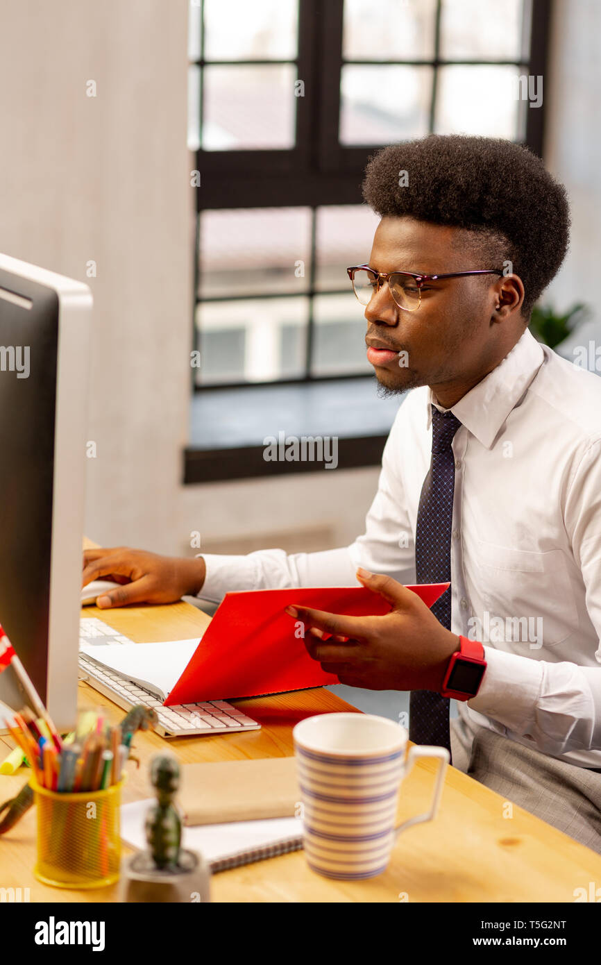 Serious office worker checking hi-res stock photography and images - Alamy