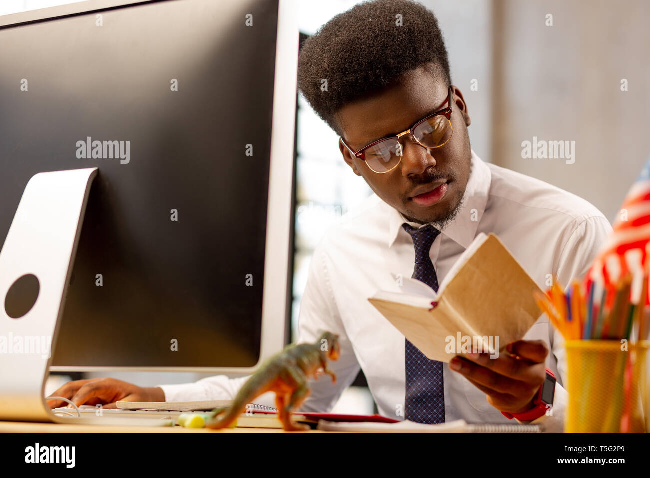 Handsome young man planning his working day Stock Photo - Alamy