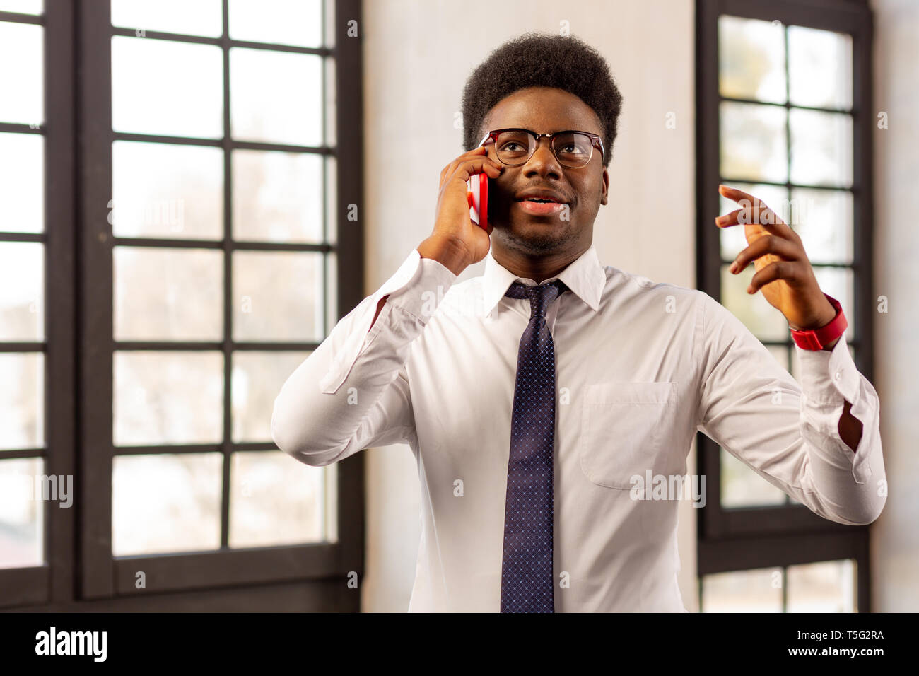 Intelligent young man discussing business issues on the phone Stock ...