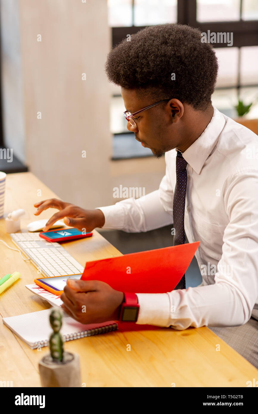 Pleasant young man pressing his smartphone screen Stock Photo - Alamy