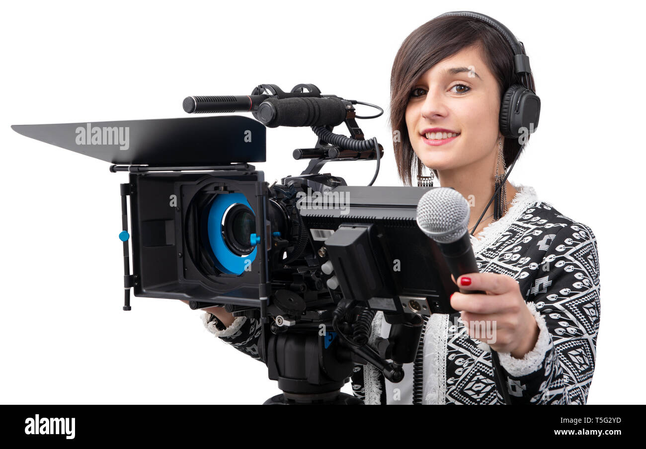 a pretty young woman journalist with microphone in television studio on ...