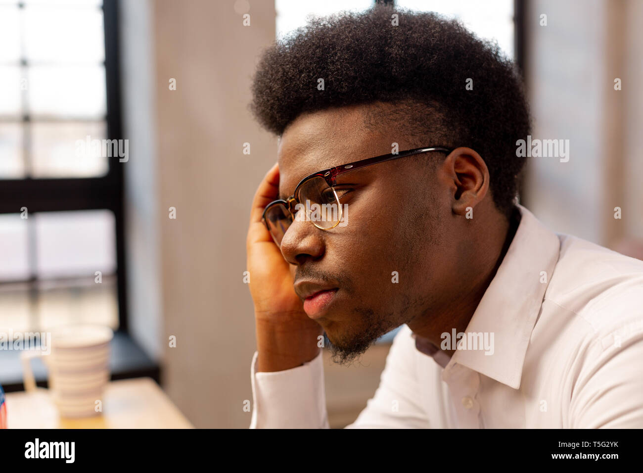 Portrait of a serious cheerless young man Stock Photo - Alamy