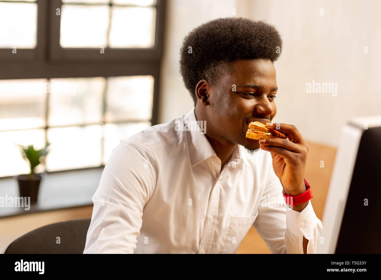 Nice African American man feeling very hungry Stock Photo - Alamy