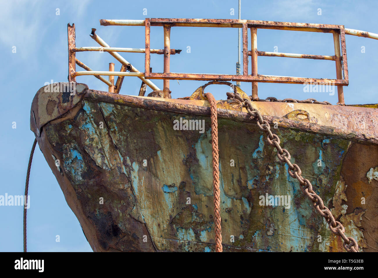 A ship wrecked fishing boat aground and abandoned rusting away on the ...