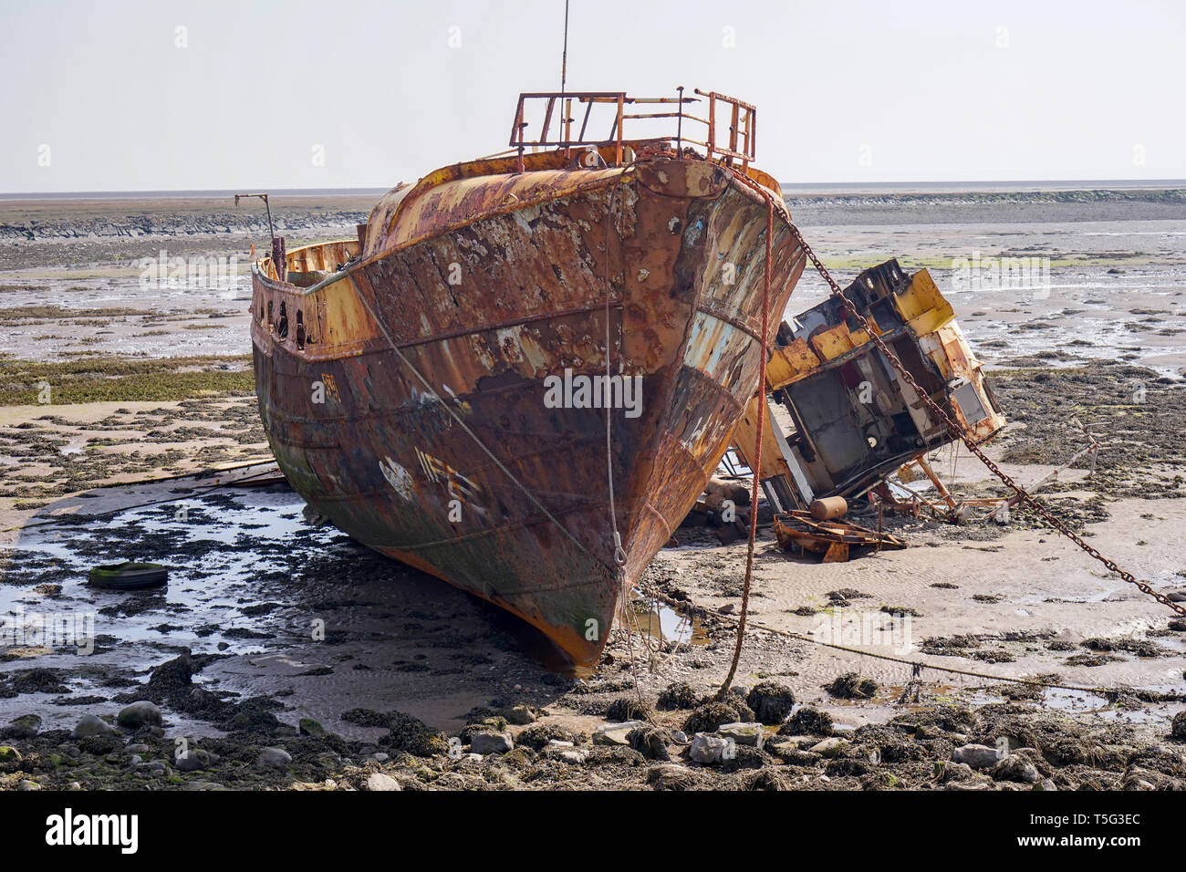 A ship wrecked fishing boat aground and abandoned rusting away on the ...