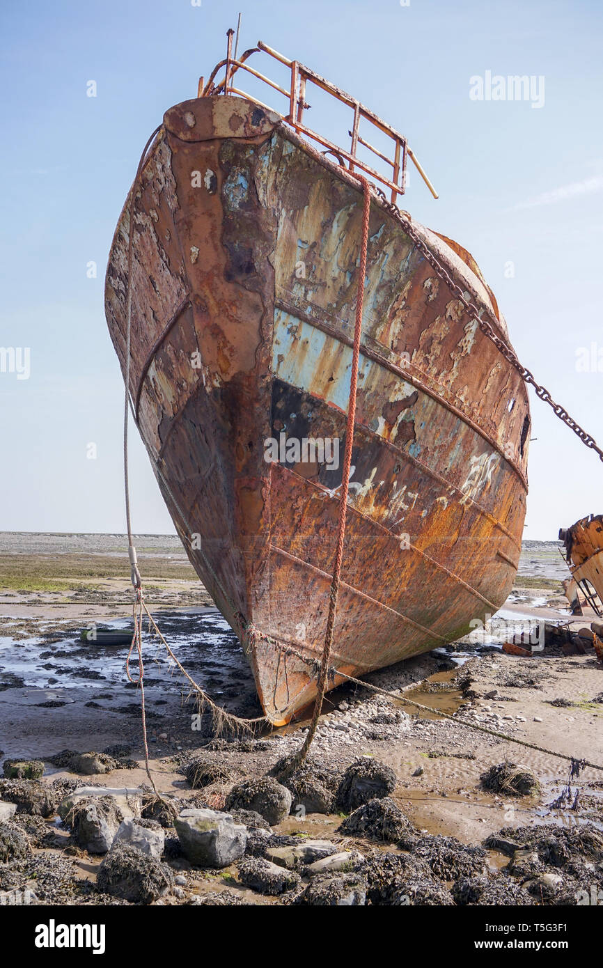 A ship wrecked fishing boat aground and abandoned rusting away on the ...