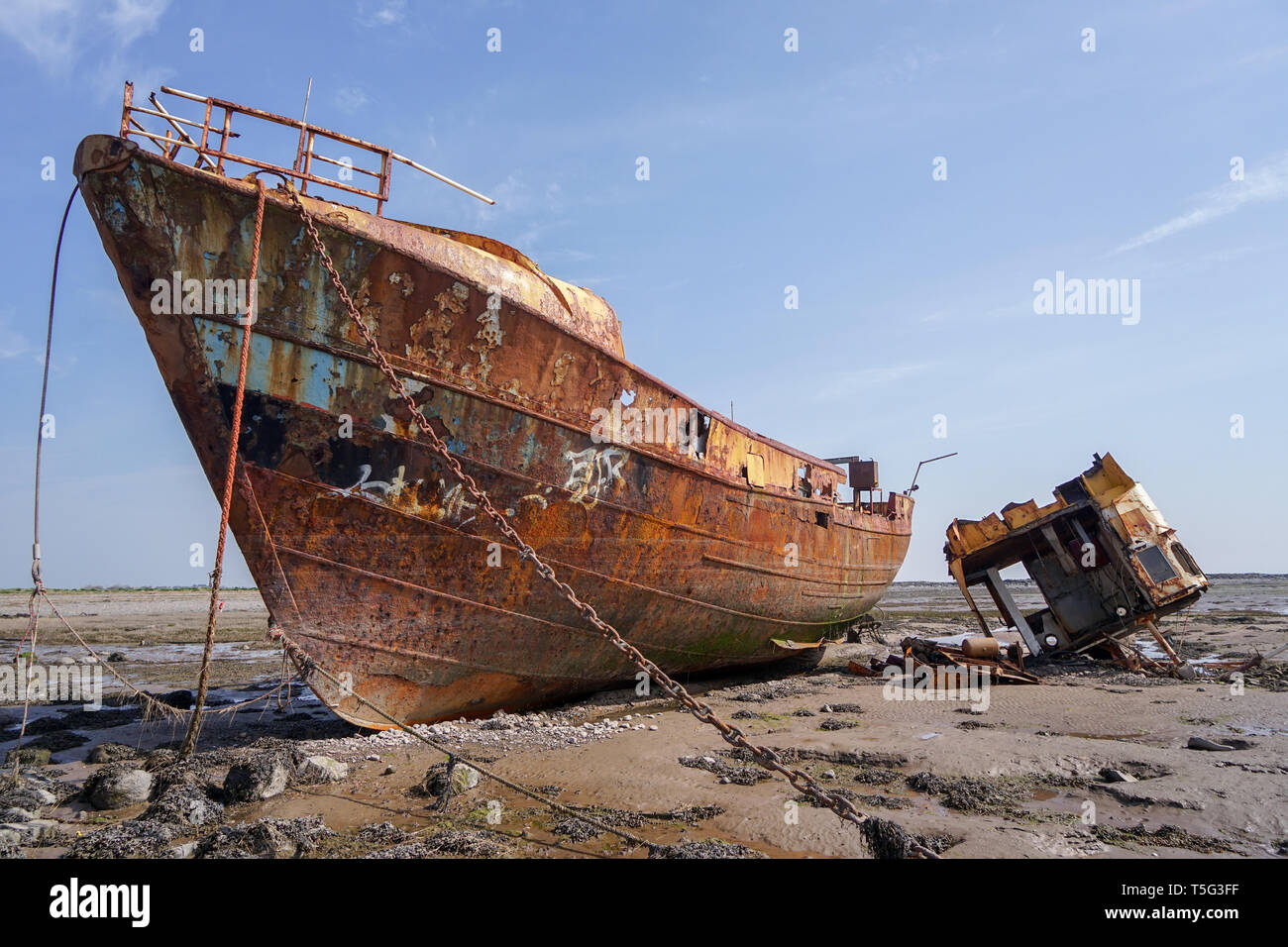 A ship wrecked fishing boat aground and abandoned rusting away on the ...