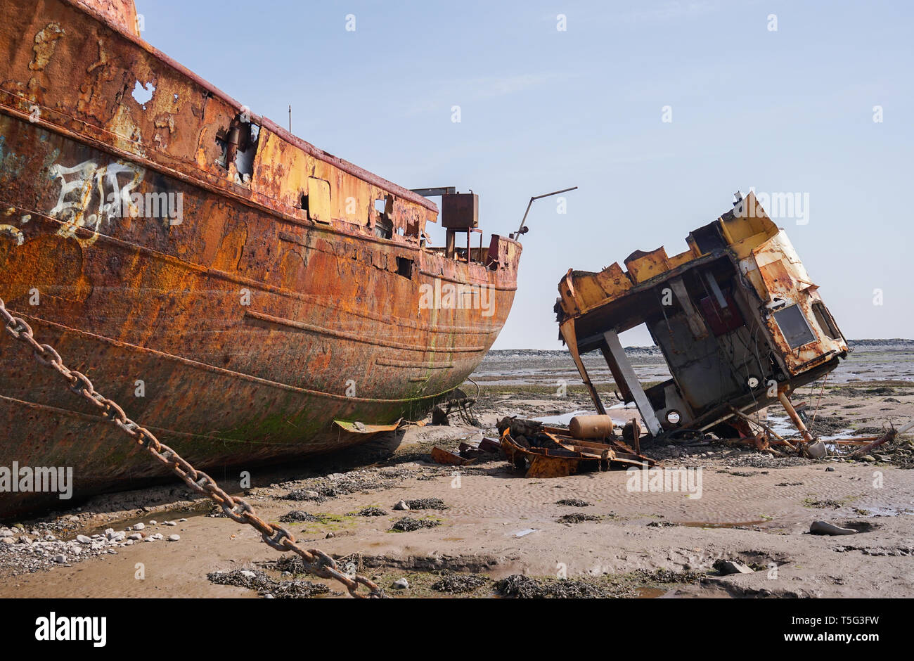 A ship wrecked fishing boat aground and abandoned rusting away on the ...