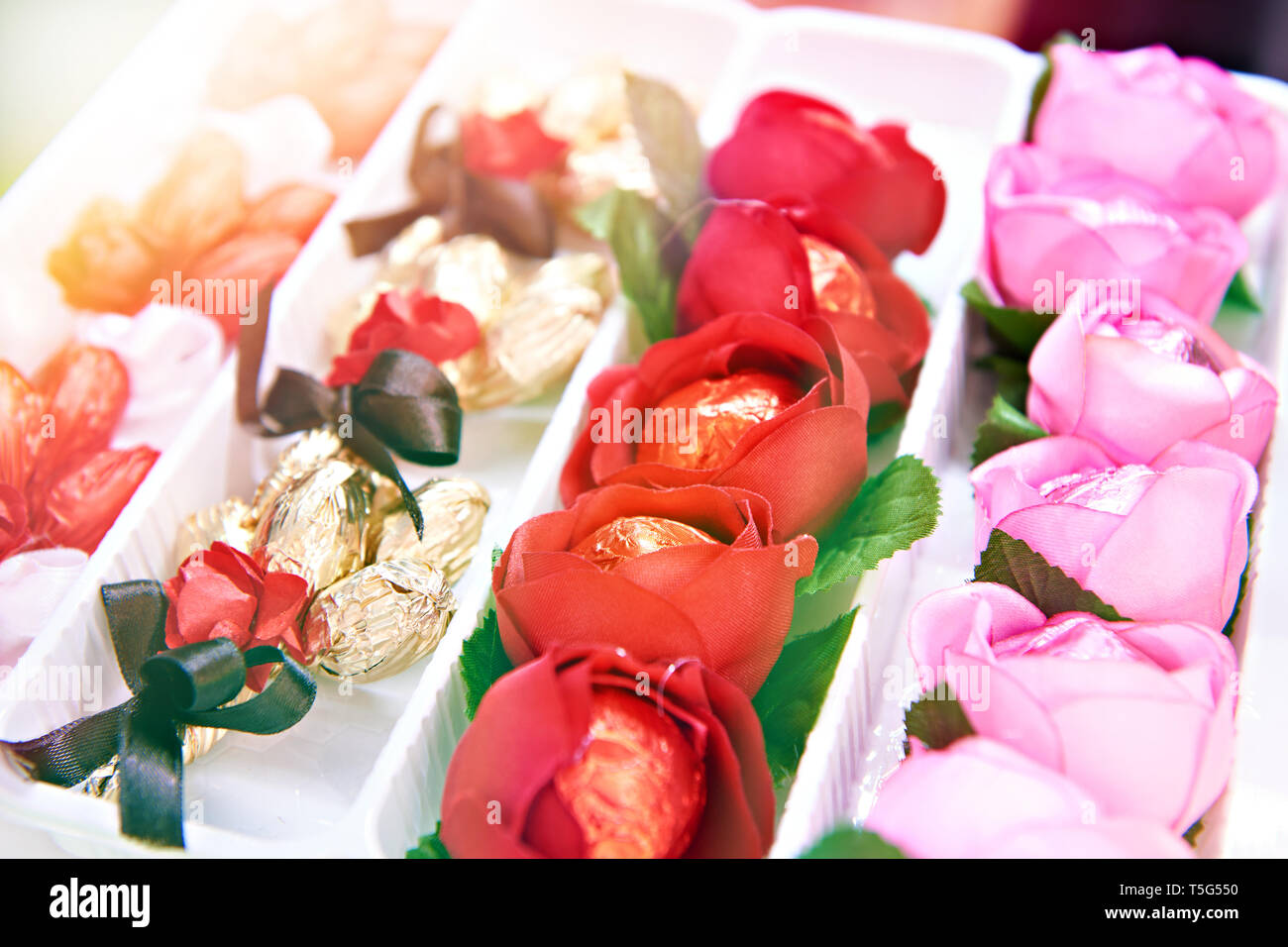 Sweets in flowers and beautiful wrappers on the store shelf Stock Photo ...