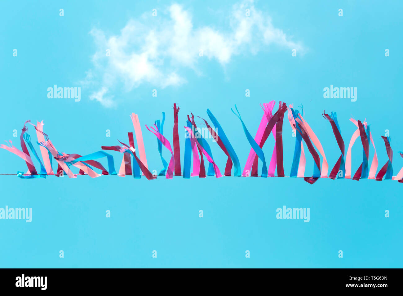 Colorful carnival strips over a blue sky Stock Photo - Alamy