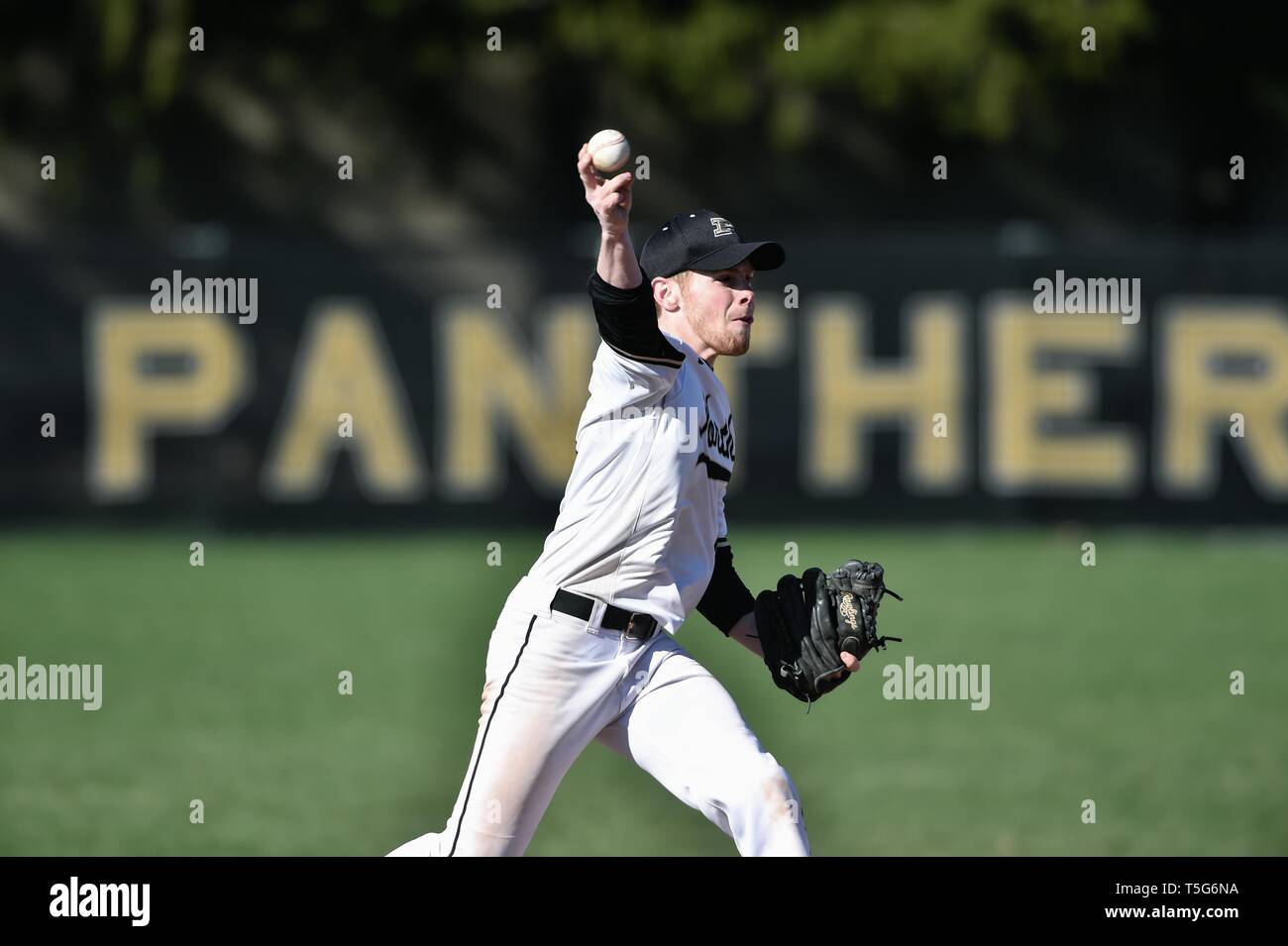 After fielding a ground ball, a third baseman fires on to first base to ...