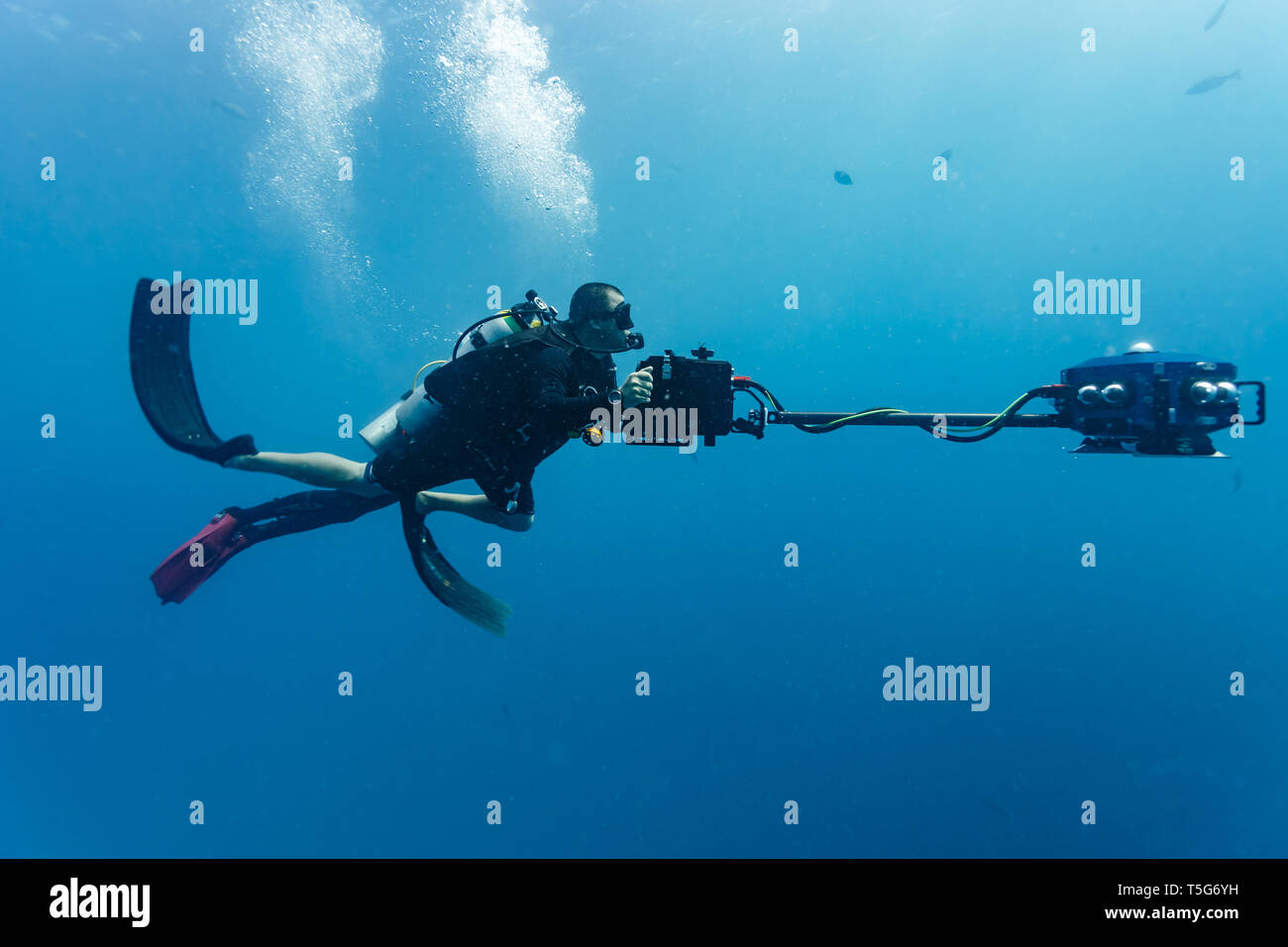 Closeup side view of cameraman diver filming with 3D camera Stock Photo ...