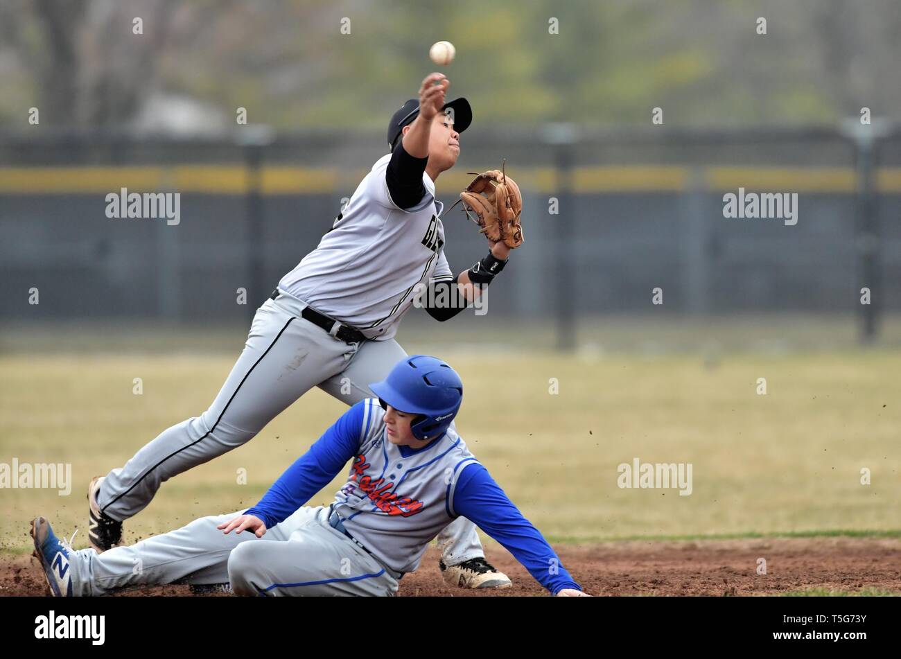 Second baseman firing on to first base to complete a double play after ...
