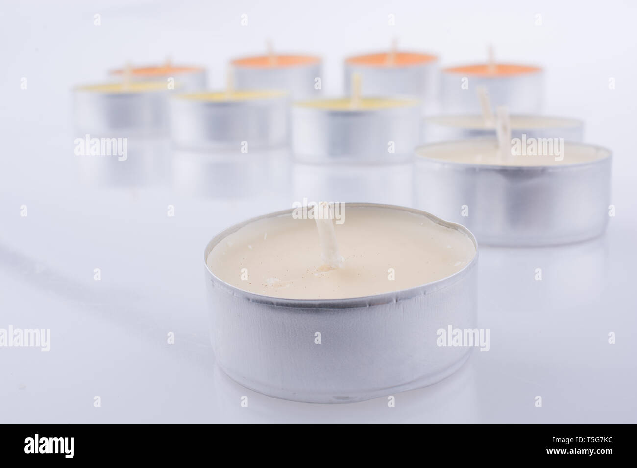 Colorful small Candles on a white background Stock Photo - Alamy