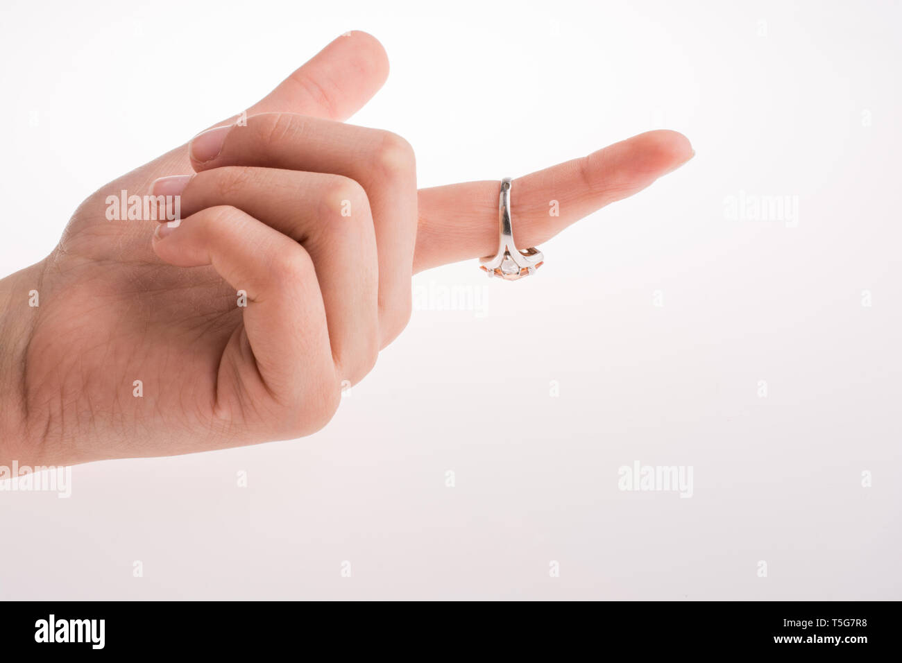 Hand wearing a ring on a white background Stock Photo - Alamy