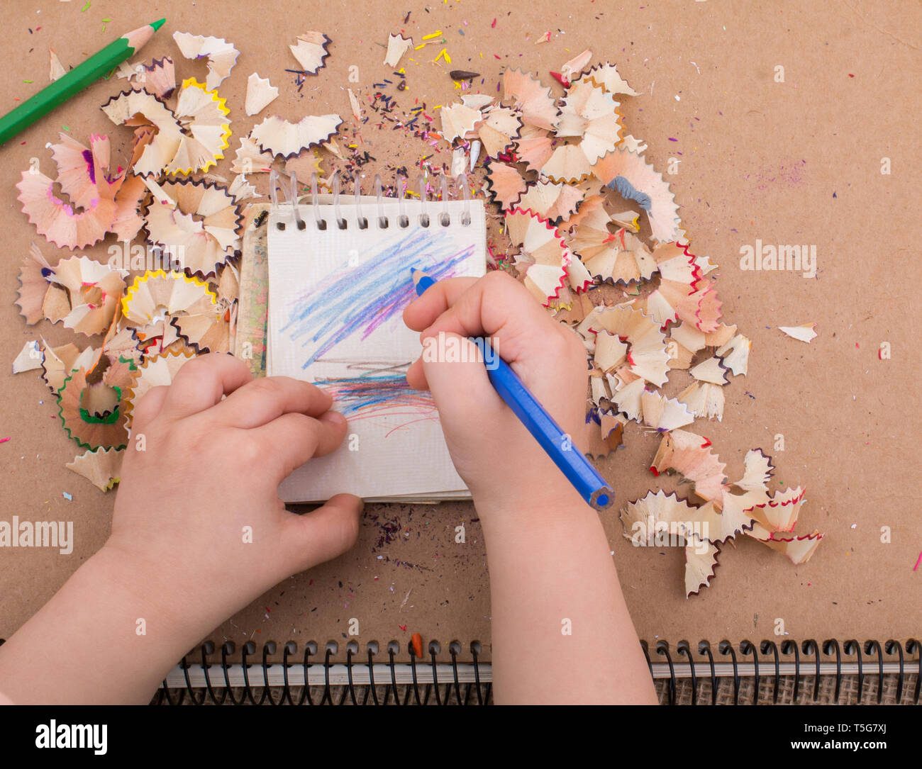 Hand holding a color pencil on spiral notebooks with pencil trash Stock ...