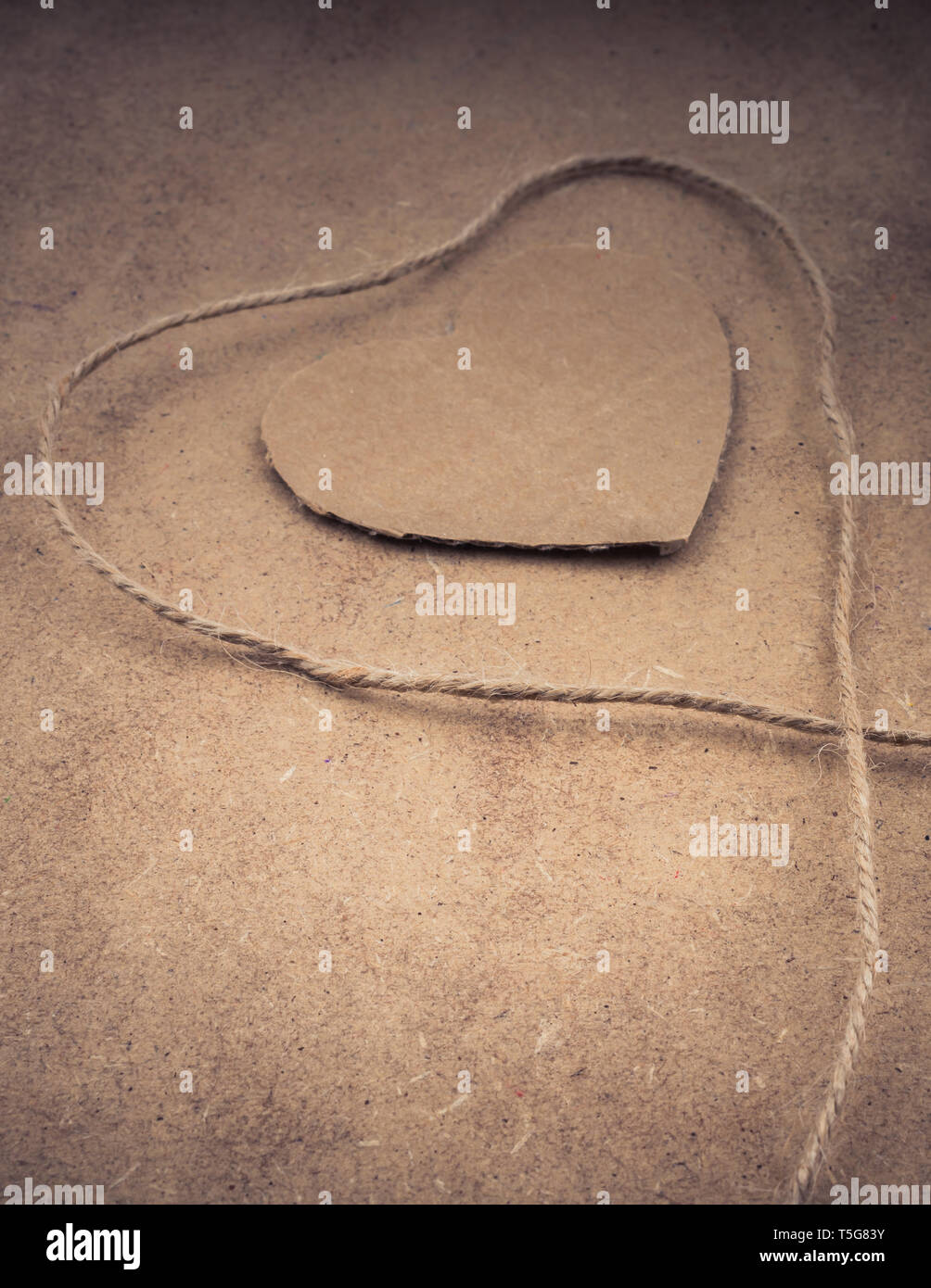 Thread off spool form a heart shape on brown background Stock Photo - Alamy