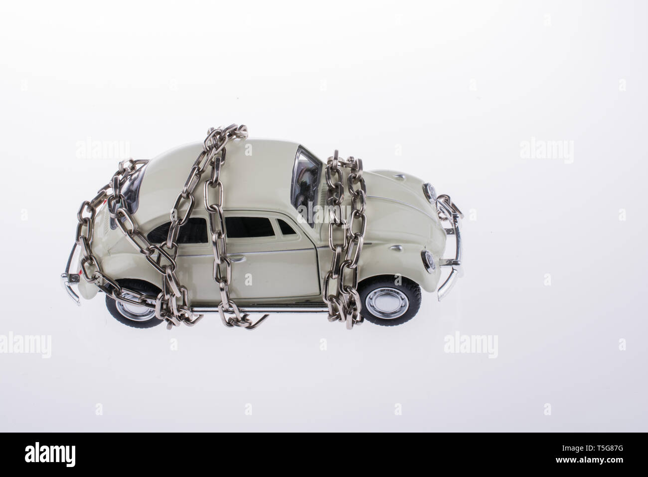 Chained white car on white background Stock Photo - Alamy