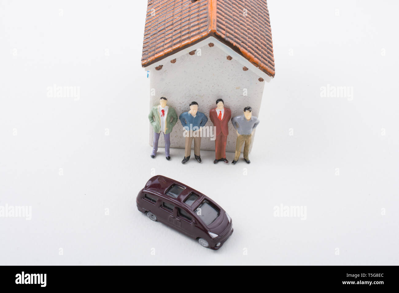 Tiny figurine of man miniature before a house Stock Photo - Alamy