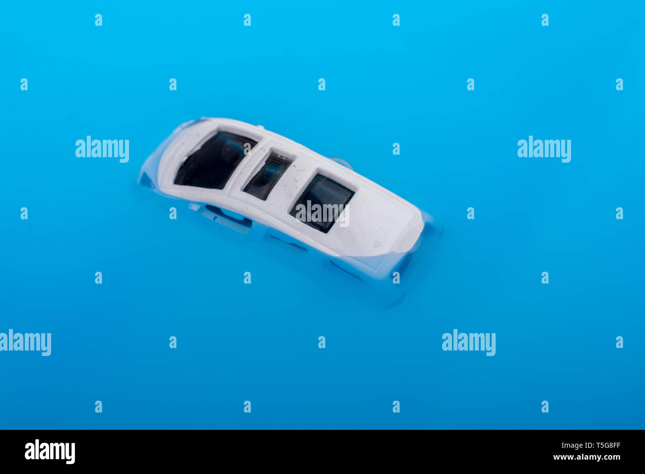 Little toy car floats in blue water Stock Photo - Alamy