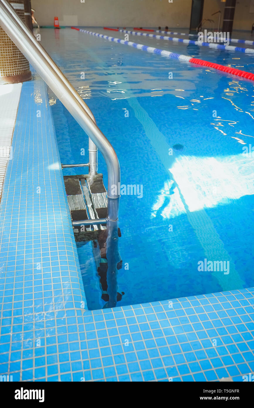 Metal swimming pool steps.Vertical image Stock Photo - Alamy