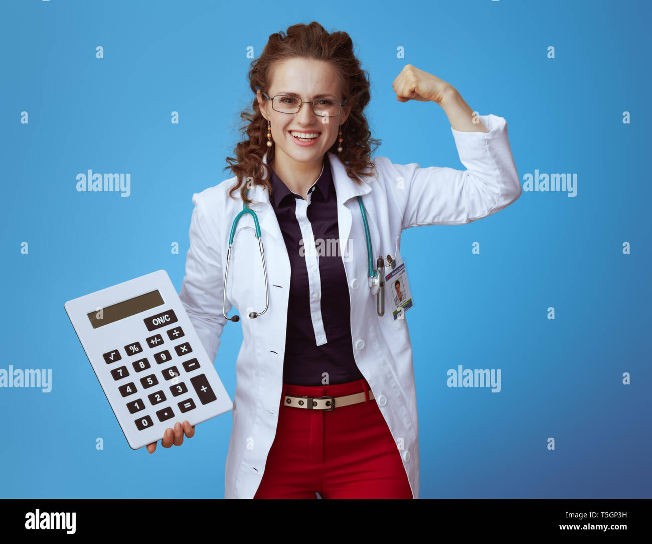 happy elegant medical doctor woman in bue shirt, red pants and white ...