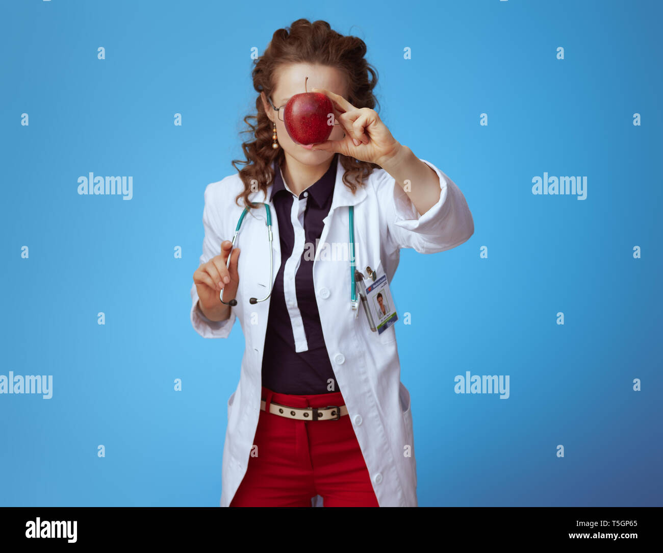 modern medical doctor woman in bue shirt, red pants and white medical ...