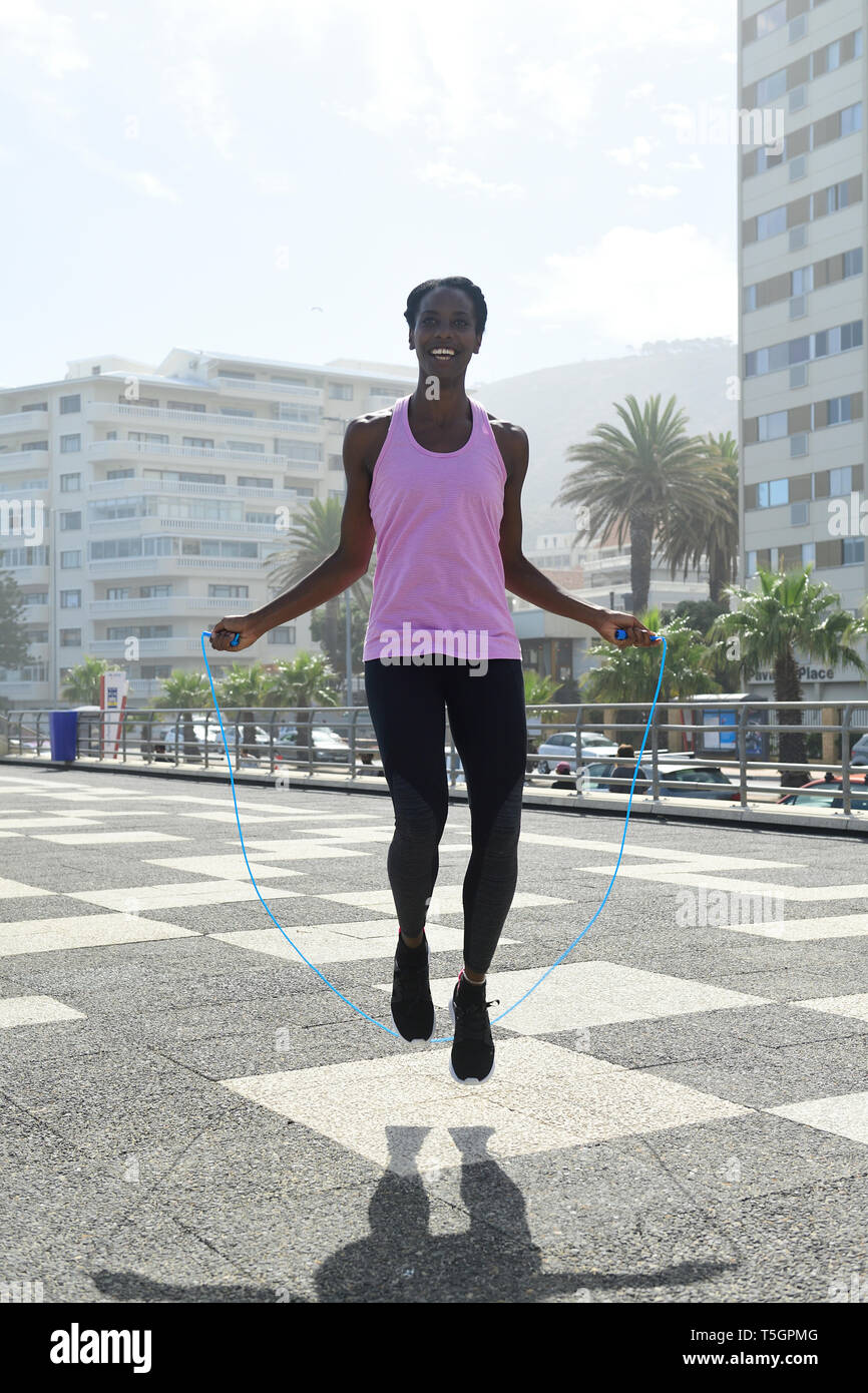 Sportive woman skipping rope outdoors Stock Photo - Alamy