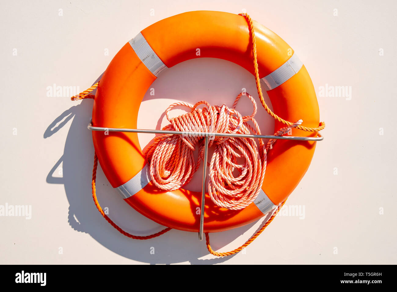 Lifebelt with lifeline on a white background on a ship Stock Photo - Alamy