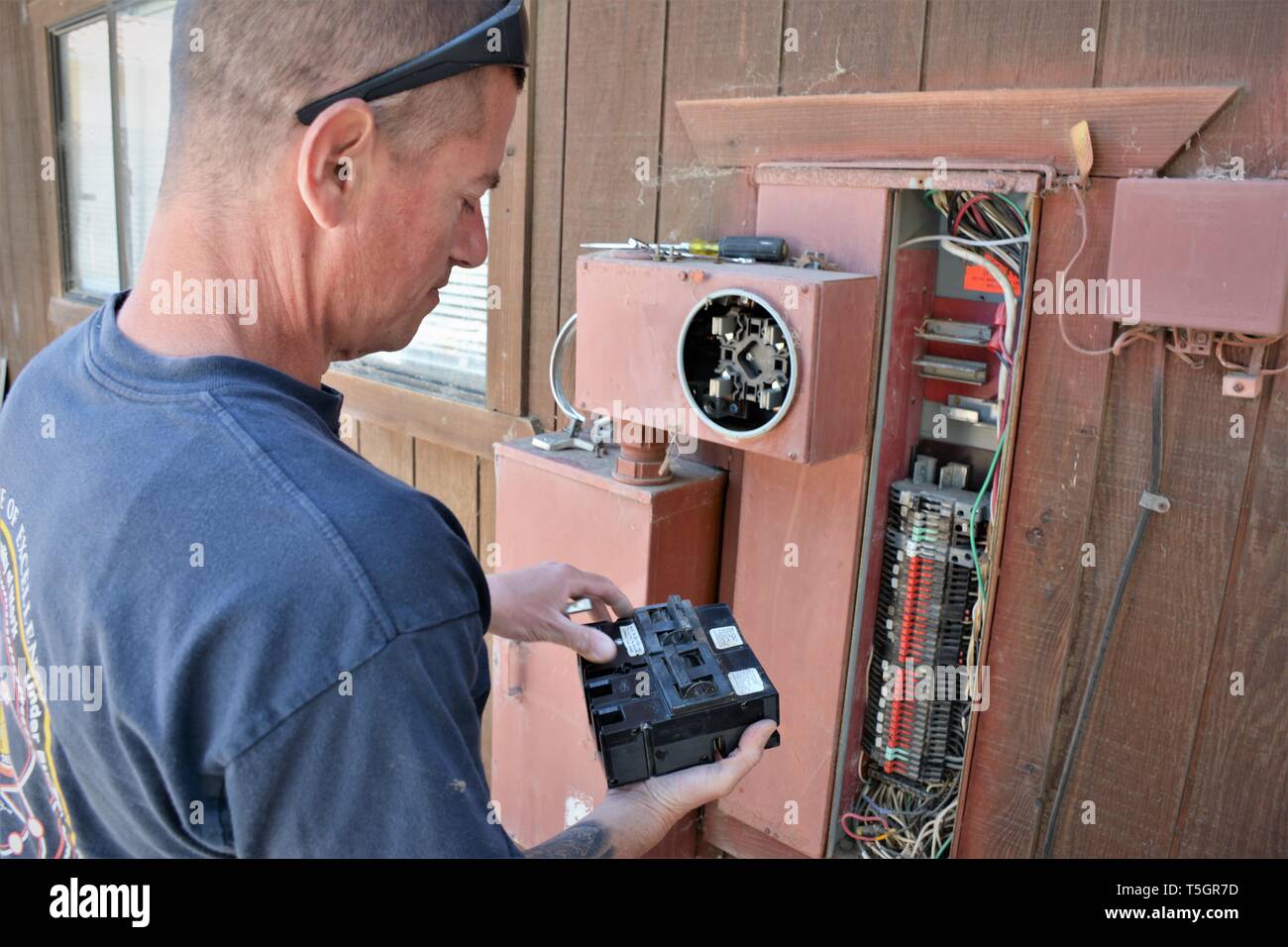 Repairs being done to faulty wiring in older home by trained and ...