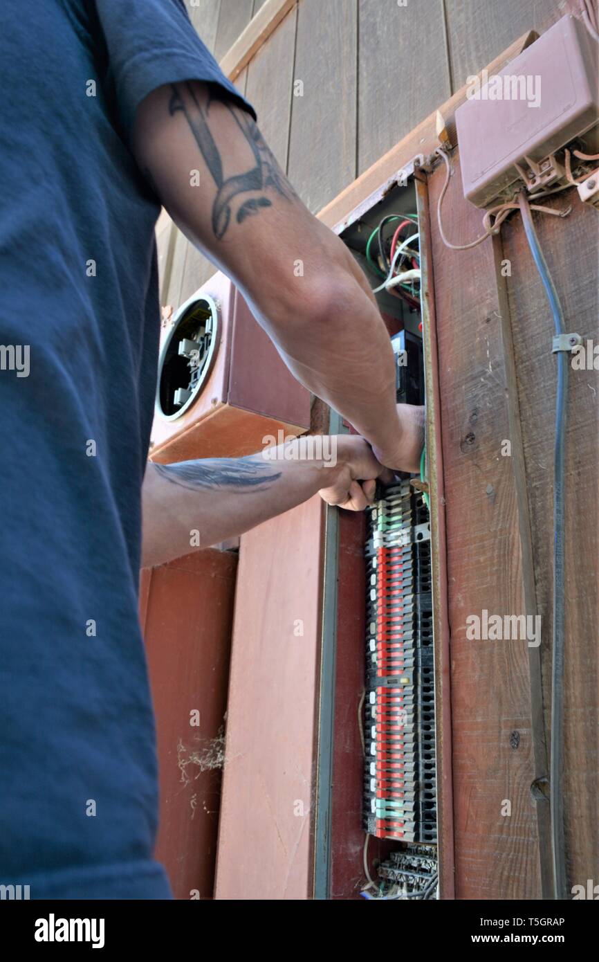 Repairs being done to faulty wiring in older home by trained and ...