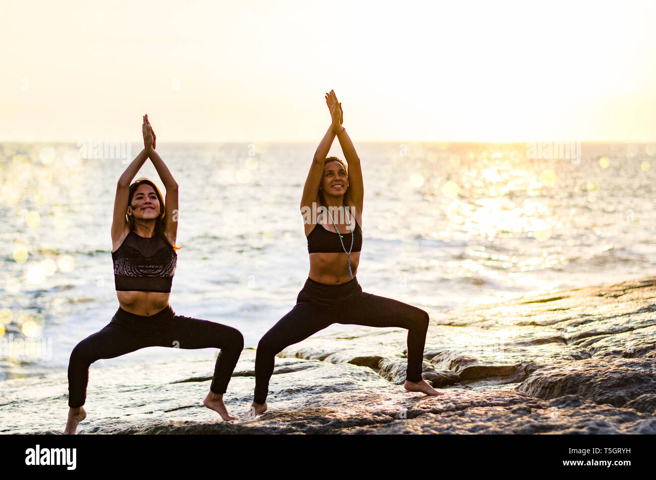 Woman yogi in a dark suit practicing yoga concept, standing in the ...