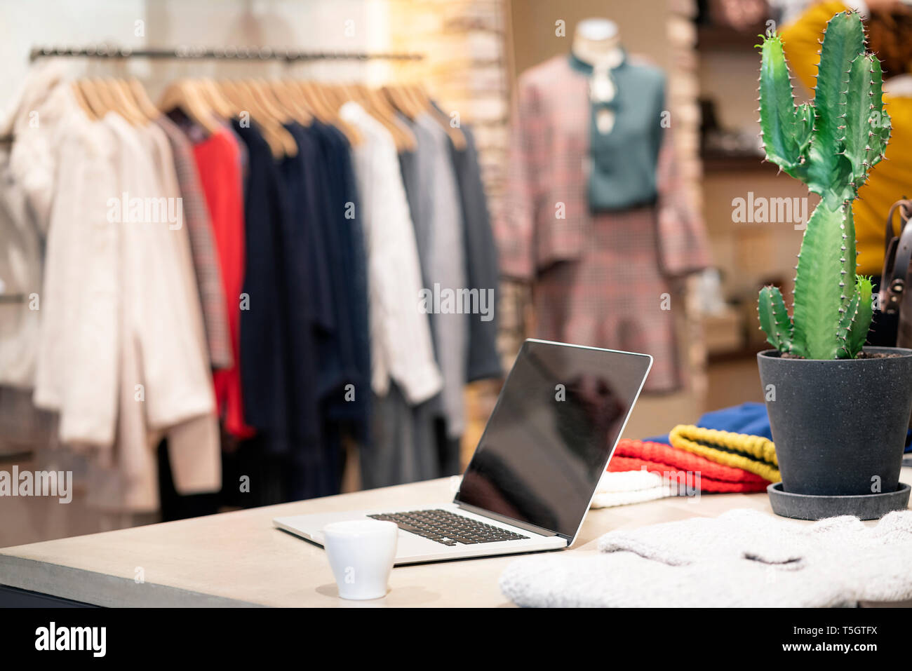 Laptop on counter in a fashion store Stock Photo - Alamy
