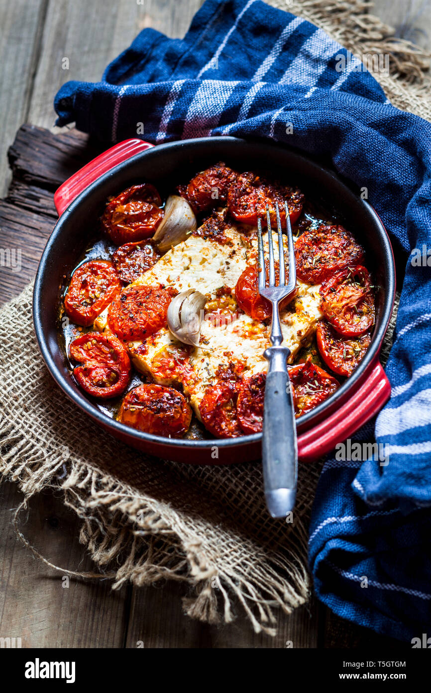 Grilled feta cheese with tomatoes and garlic Stock Photo - Alamy